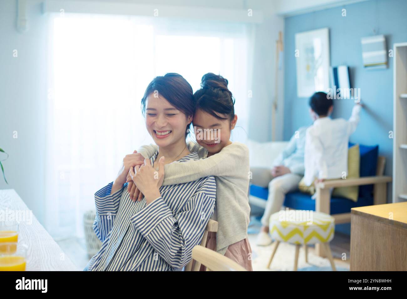 Daughter hugging her mother Stock Photo - Alamy