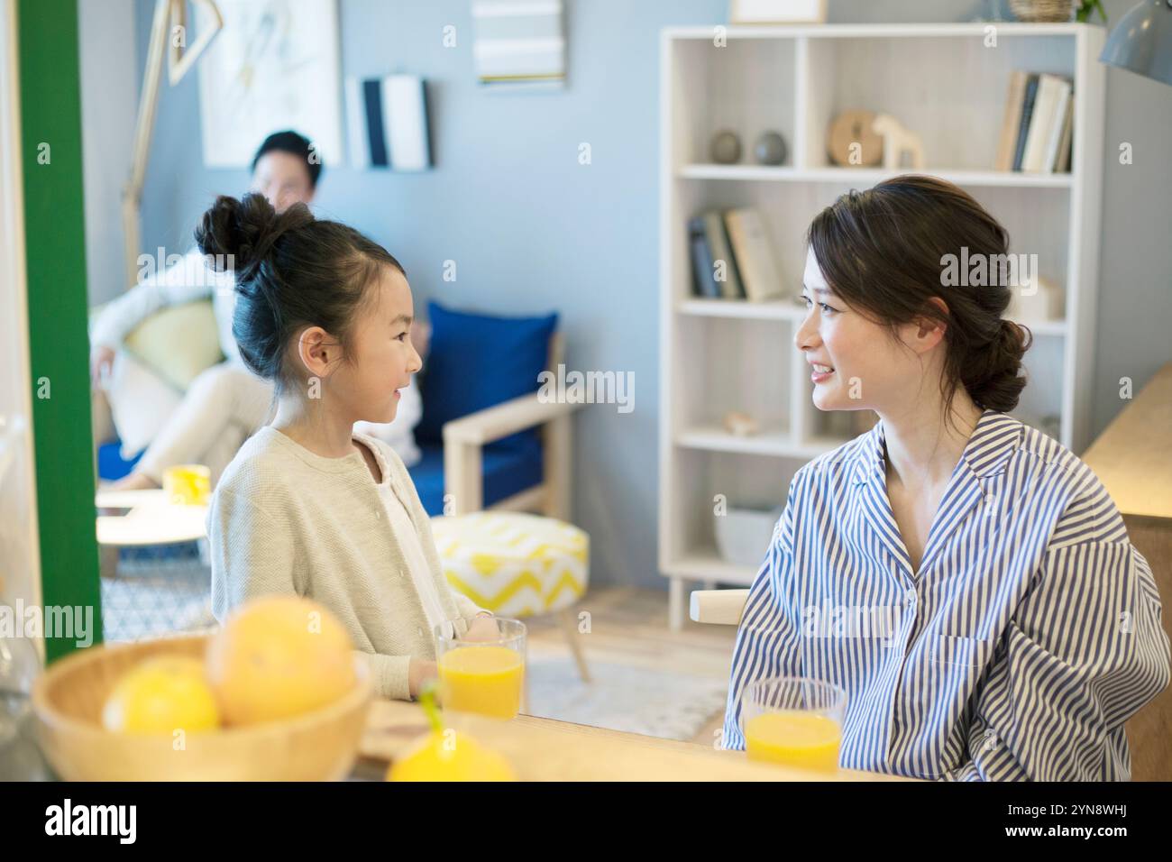 Happy parents and children talking in the living room Stock Photo - Alamy