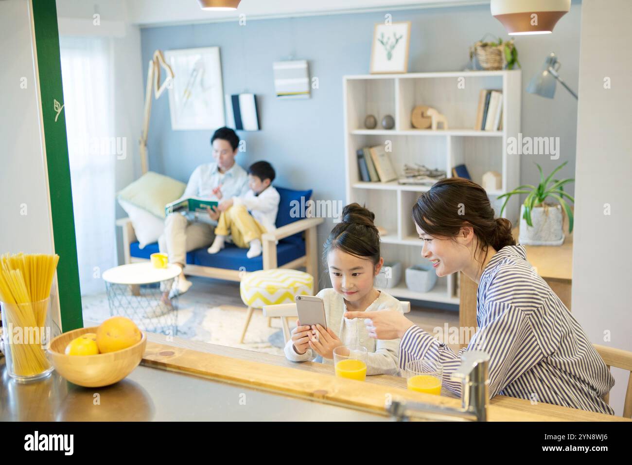 Happy family spending time in the living room Stock Photo - Alamy