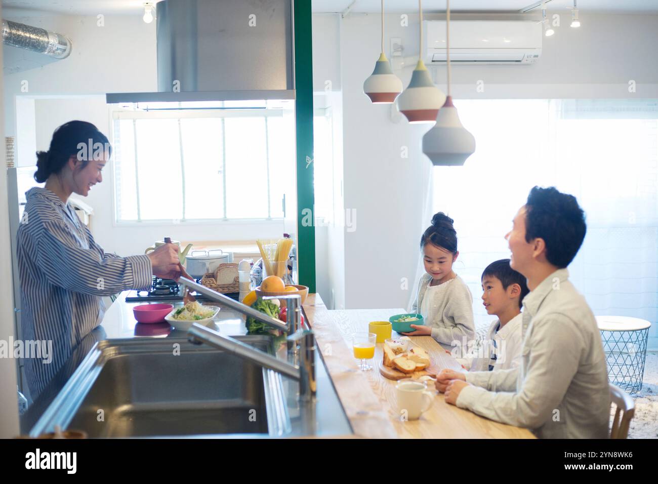 Happy family dining scene Stock Photo - Alamy