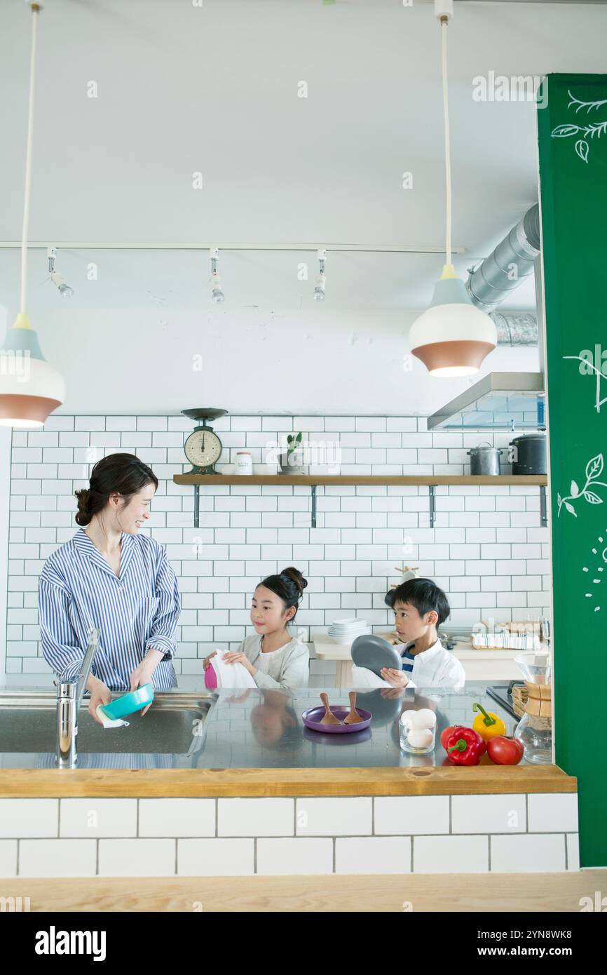Smiling parents and children washing dishes Stock Photo - Alamy