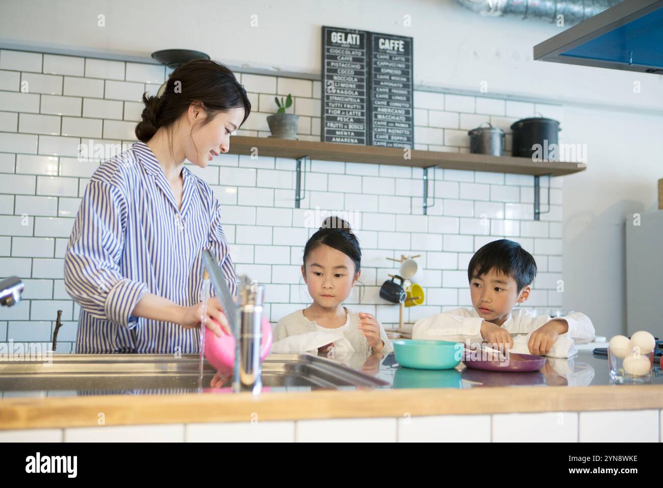 Smiling parents and children washing dishes Stock Photo - Alamy