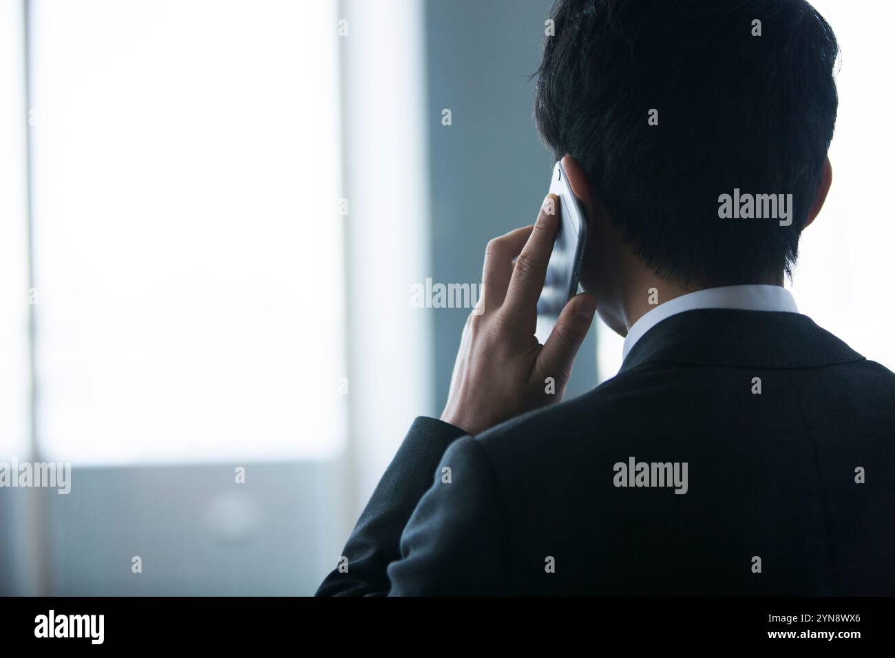 Back view of man making a phone call Stock Photo - Alamy