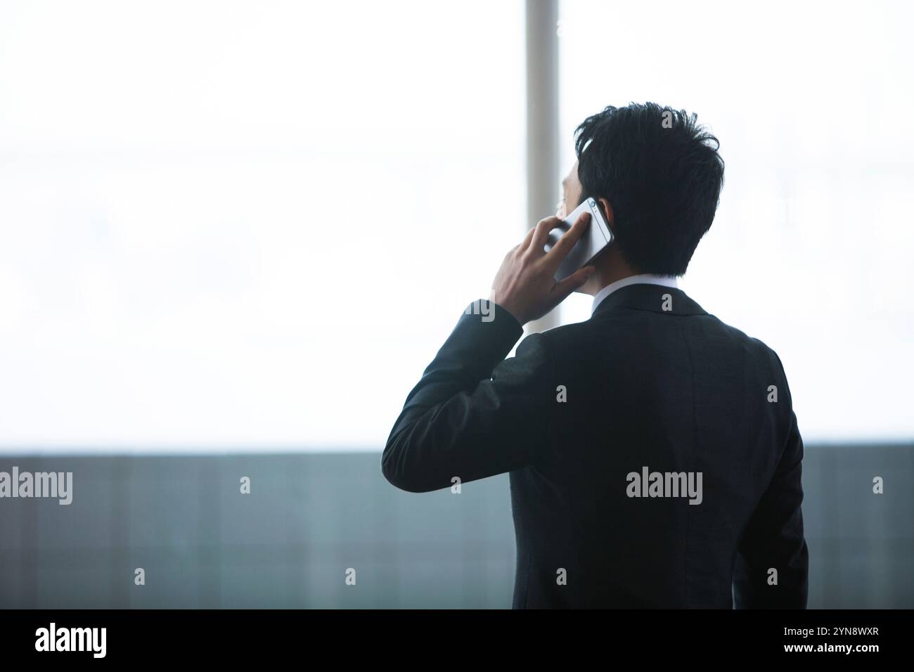 Back view of man making a phone call Stock Photo - Alamy