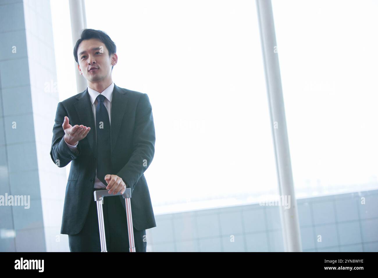 Man in his 20s in a suit explaining Stock Photo - Alamy