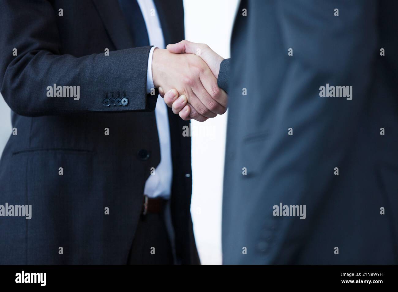 Two men in suit handshake hi-res stock photography and images - Alamy