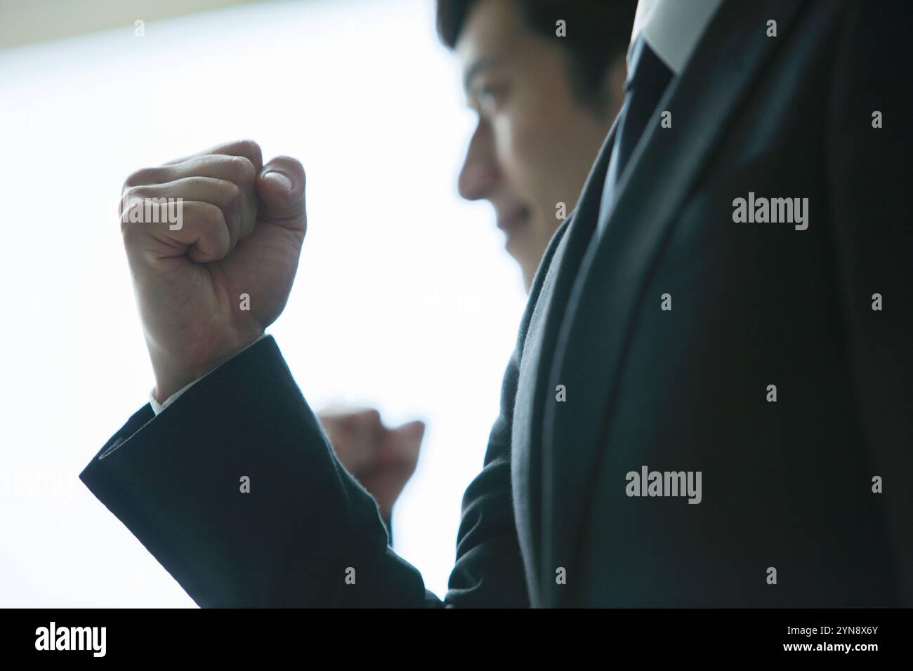 Hand of a man in his 20s in a suit posing with guts Stock Photo - Alamy
