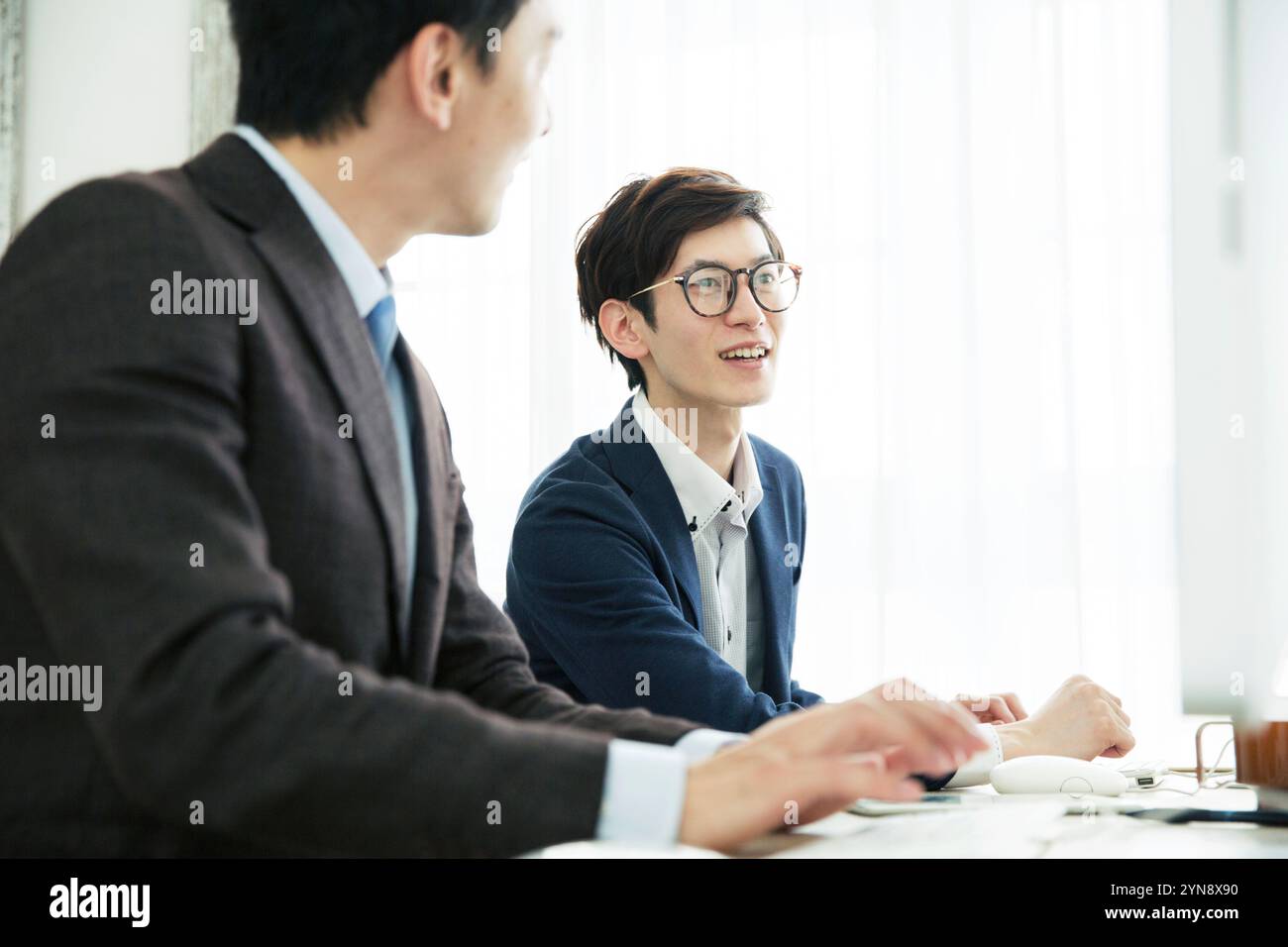 Office work scene of men in their 20s Stock Photo - Alamy
