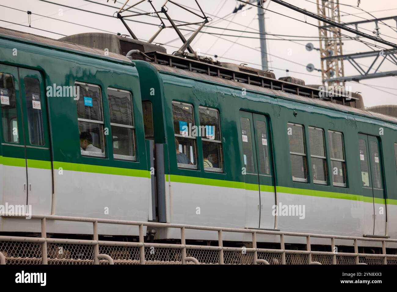 Japanese Commuter Train Passing Through Suburban Tracks Stock Photo - Alamy