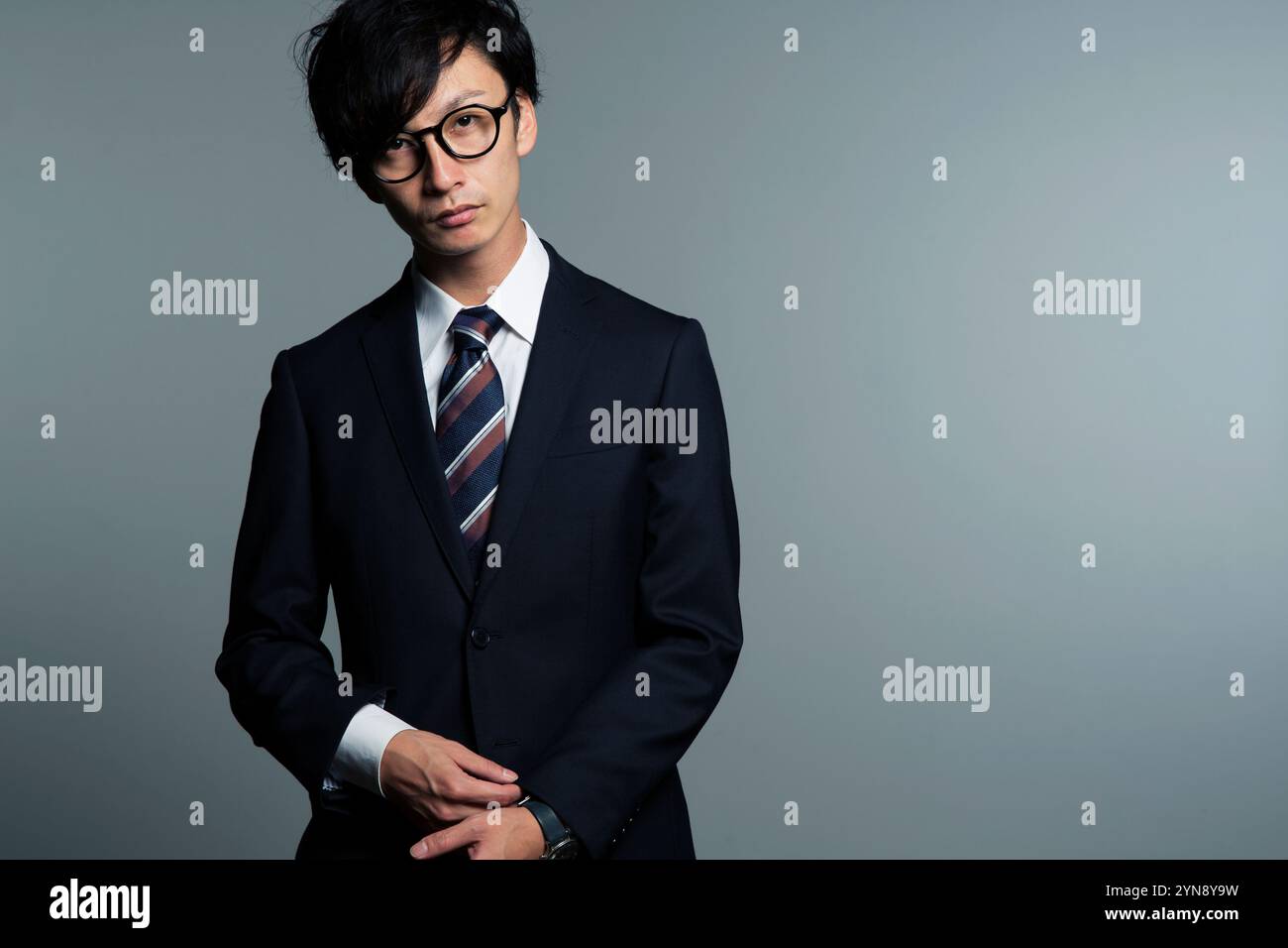 Portrait of camera-ready man in suit Stock Photo - Alamy