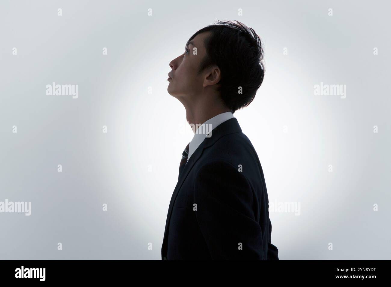 Profile of man in suit looking upwards Stock Photo - Alamy
