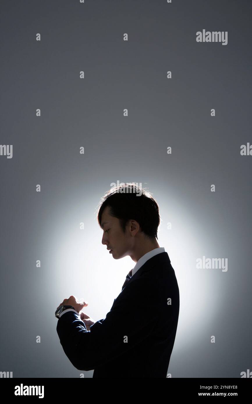 Side view of man touching cuff of suit Stock Photo - Alamy