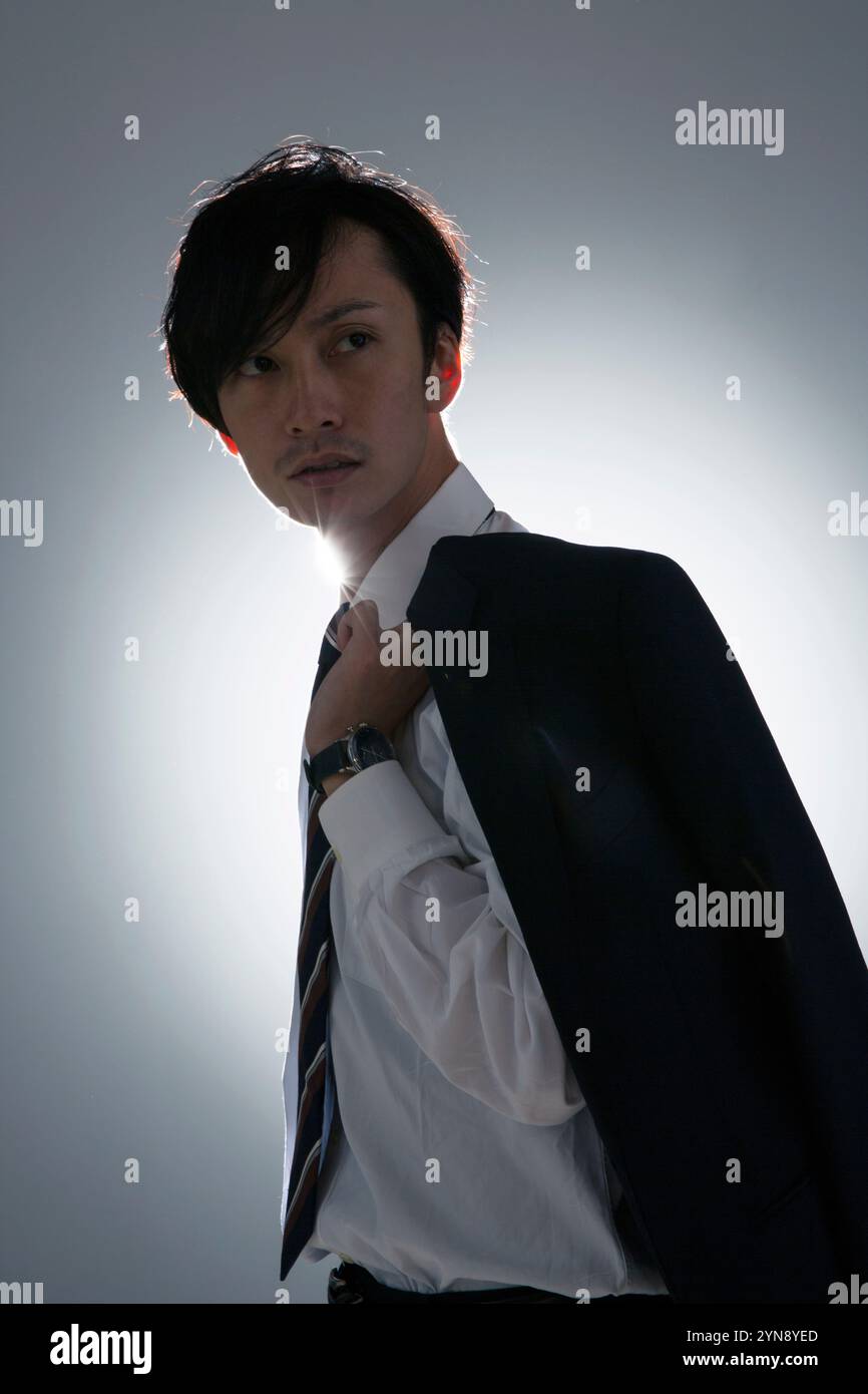 Side view of man with suit on his shoulder Stock Photo - Alamy