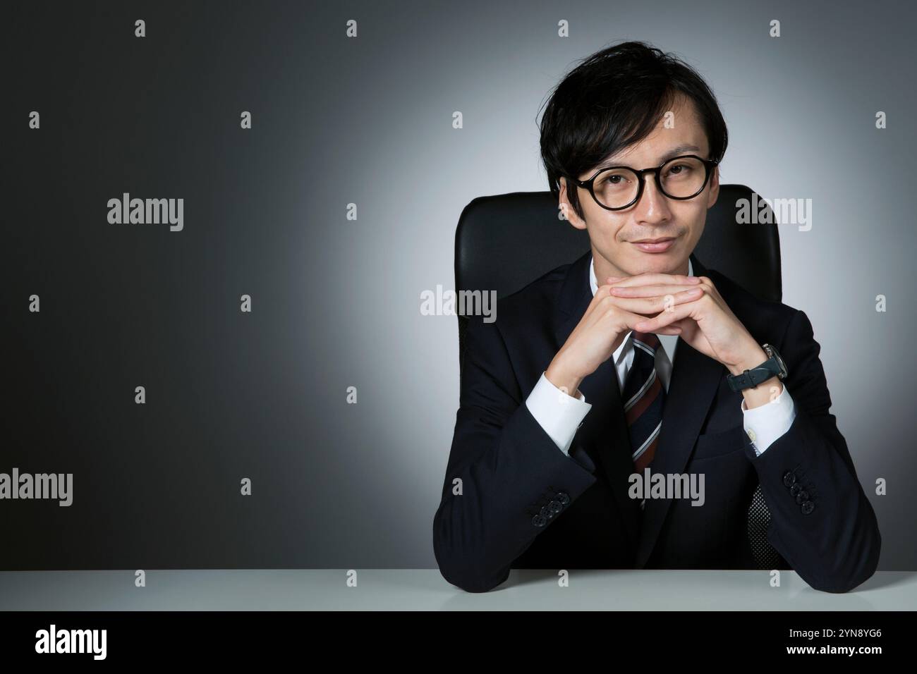 Portrait of a man thinking, resting on his elbows Stock Photo - Alamy