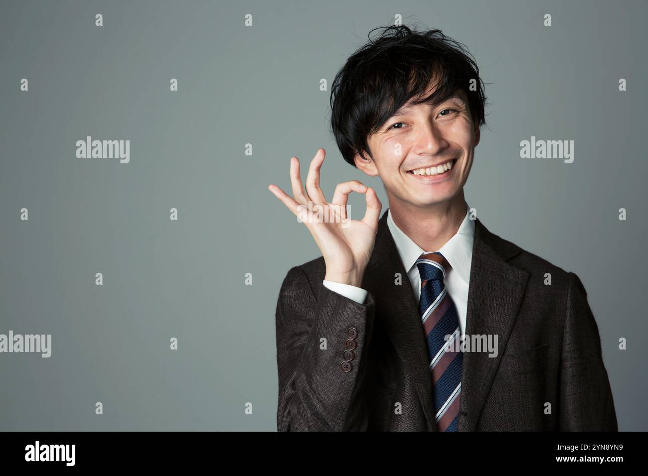 Smiling man posing with an ‘okay’ sign Stock Photo - Alamy