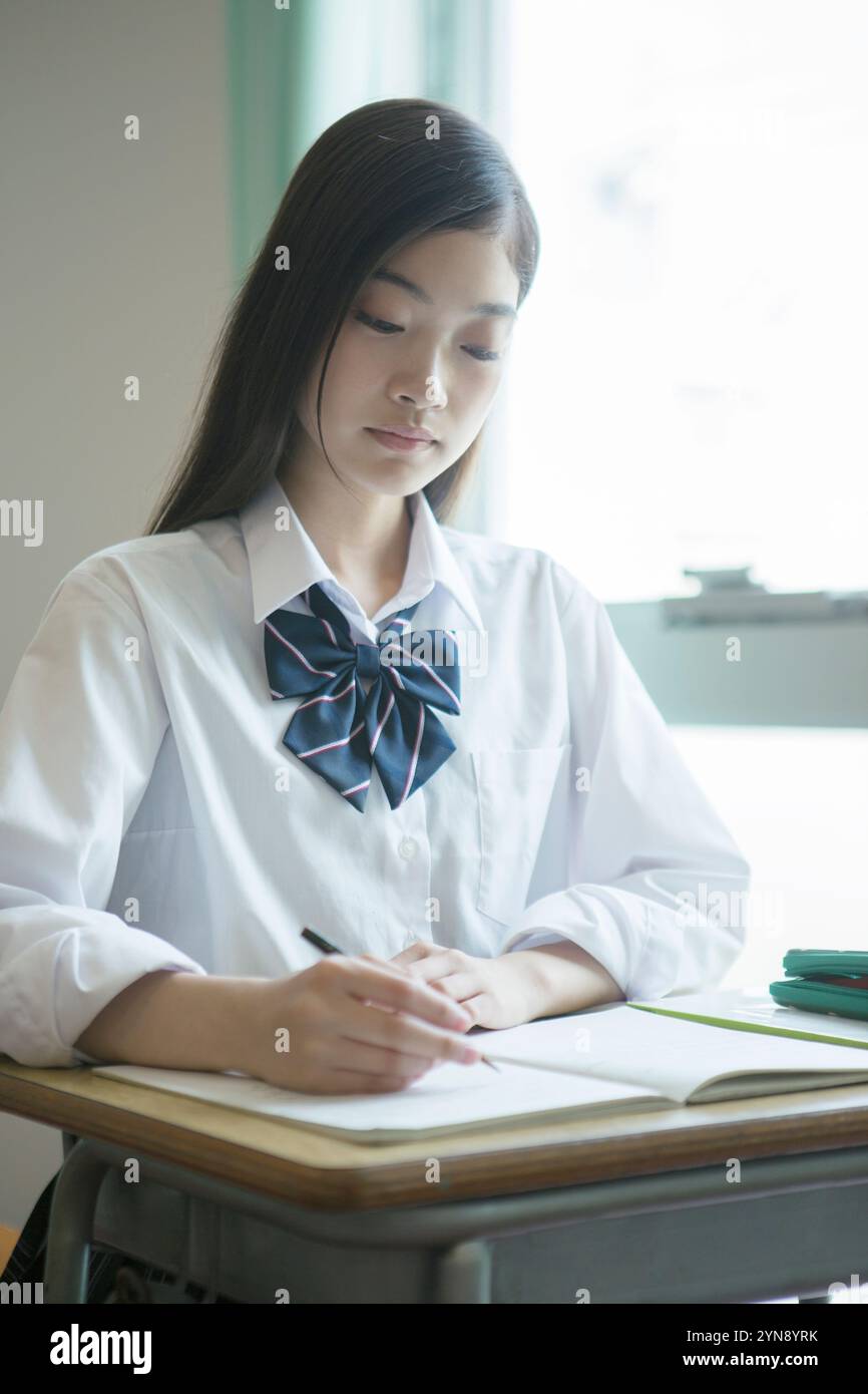 High school girls studying in a classroom Stock Photo - Alamy