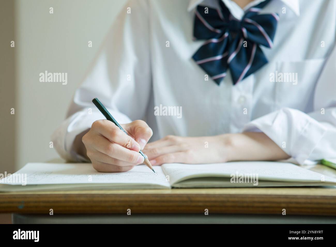 Hand of a female college student taking notes using a pencil Stock ...