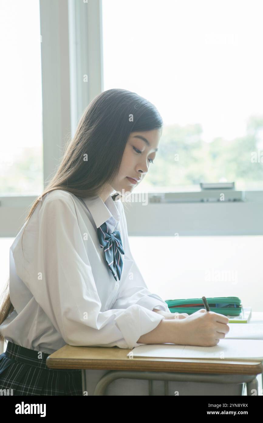 High school girls studying in a classroom Stock Photo - Alamy