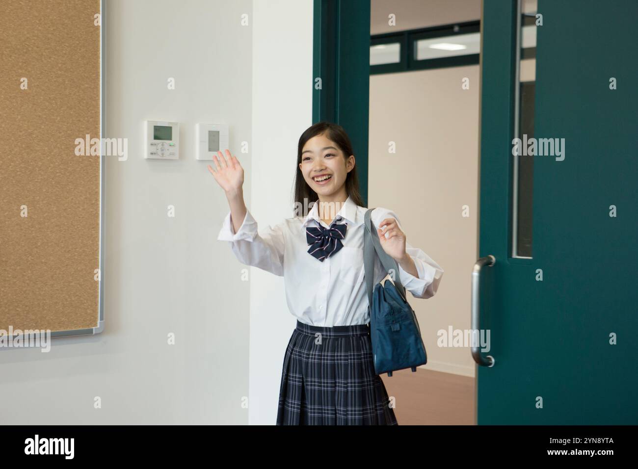 Female high school students waving in the classroom Stock Photo - Alamy