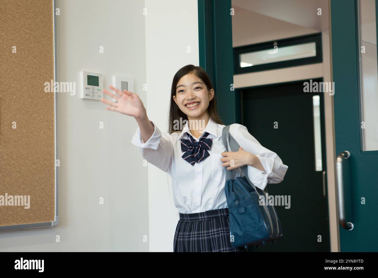 Female high school students waving in the classroom Stock Photo - Alamy