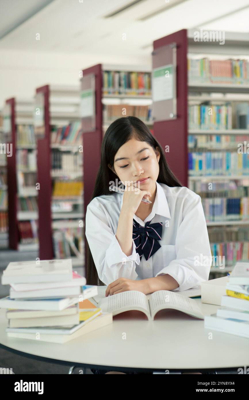 High school girls fed up with piles of studying Stock Photo - Alamy