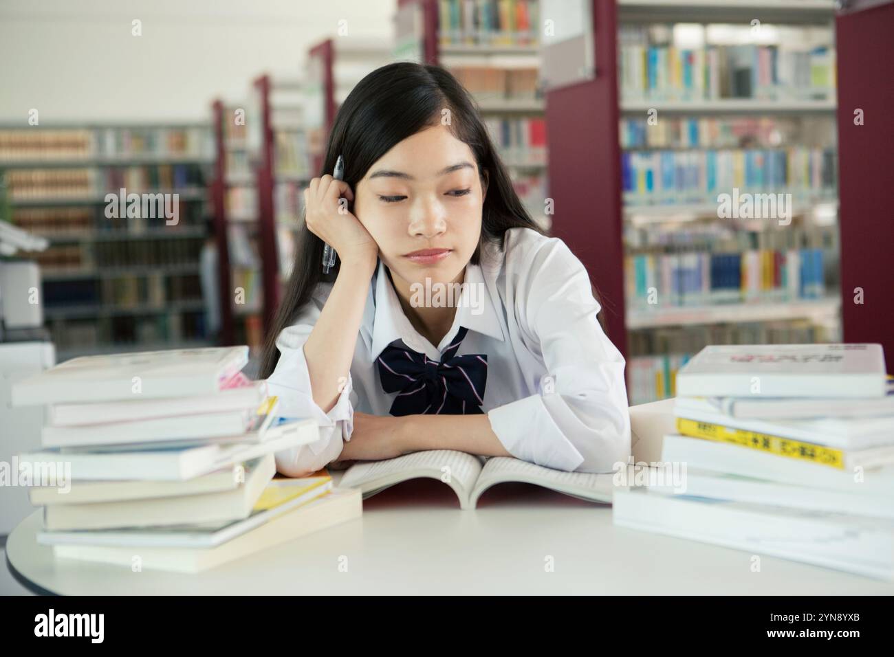 High school girls fed up with piles of studying Stock Photo - Alamy