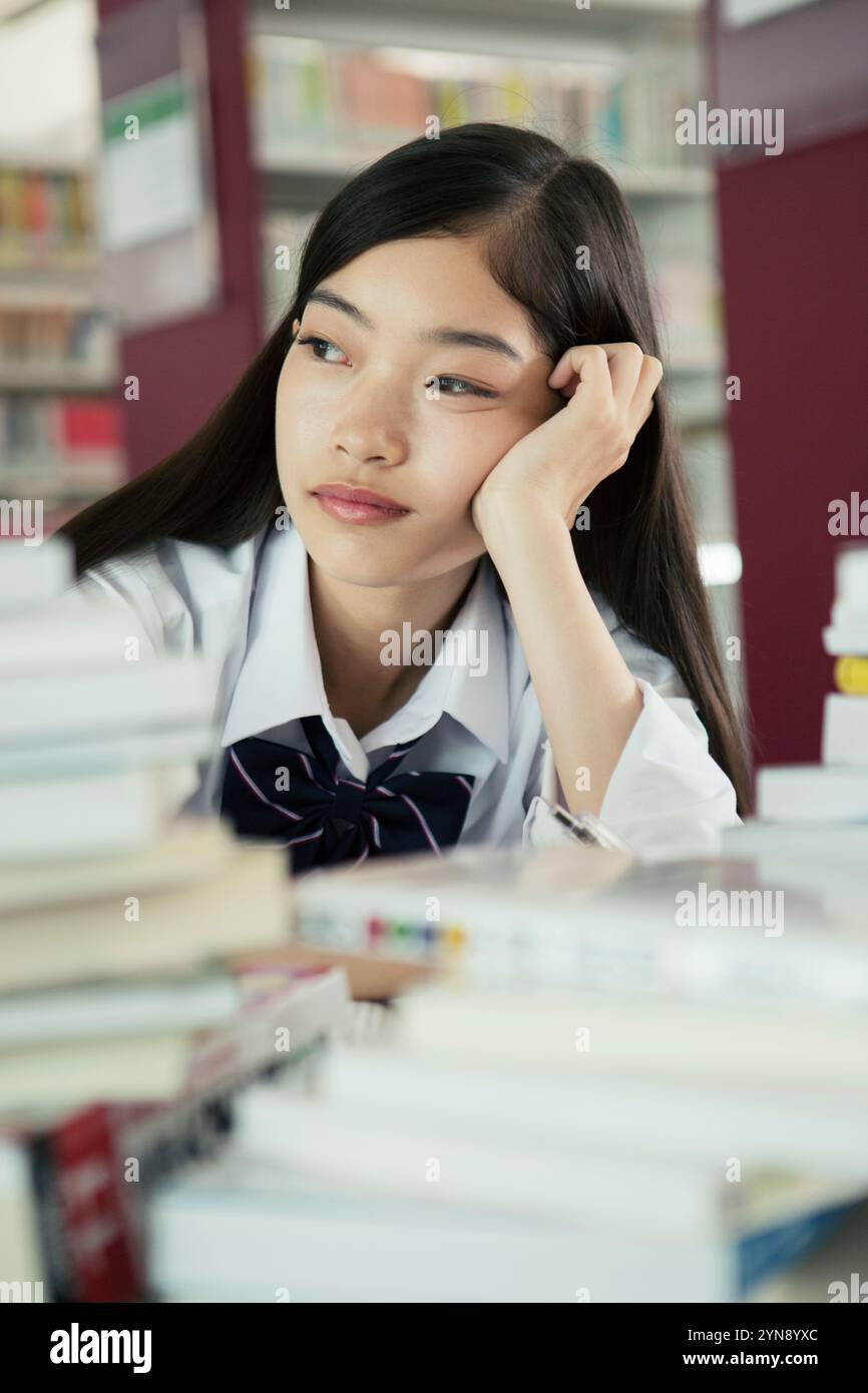 High school girls fed up with piles of studying Stock Photo - Alamy