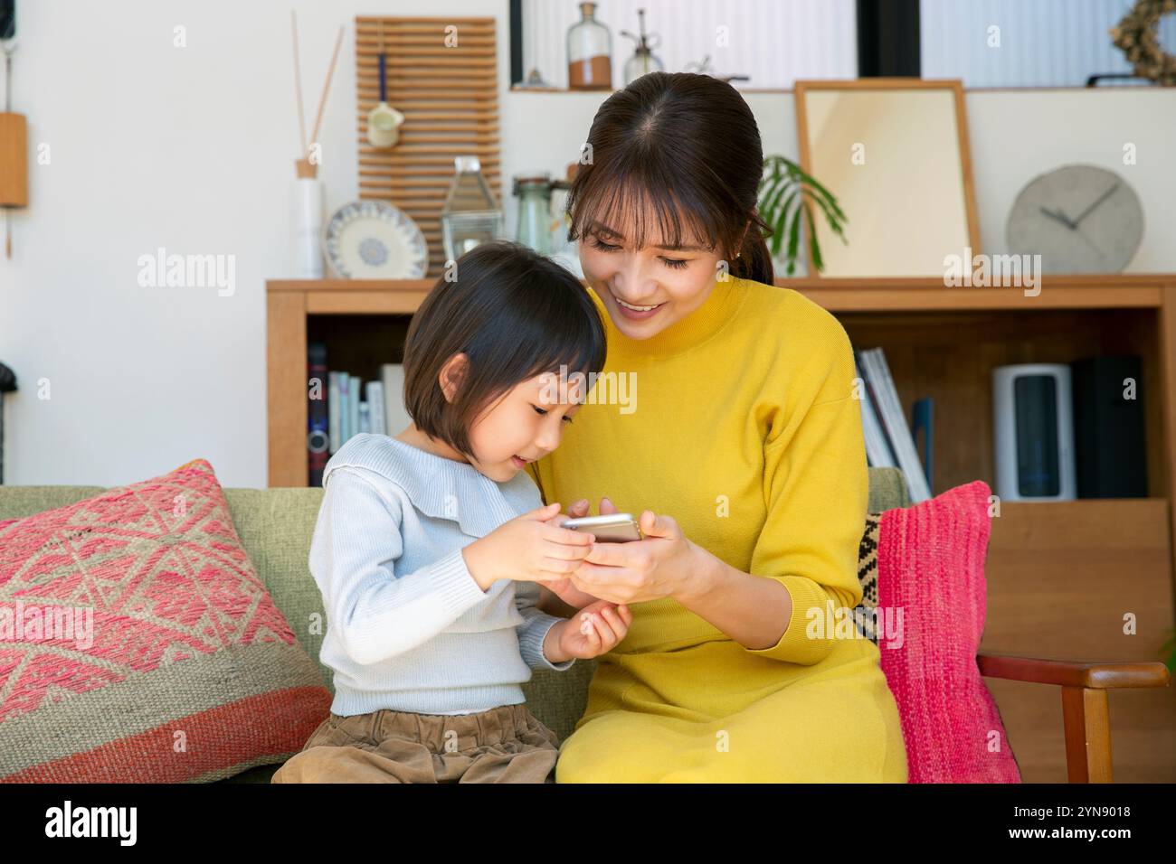 Parent and child relaxing in the living room Stock Photo - Alamy