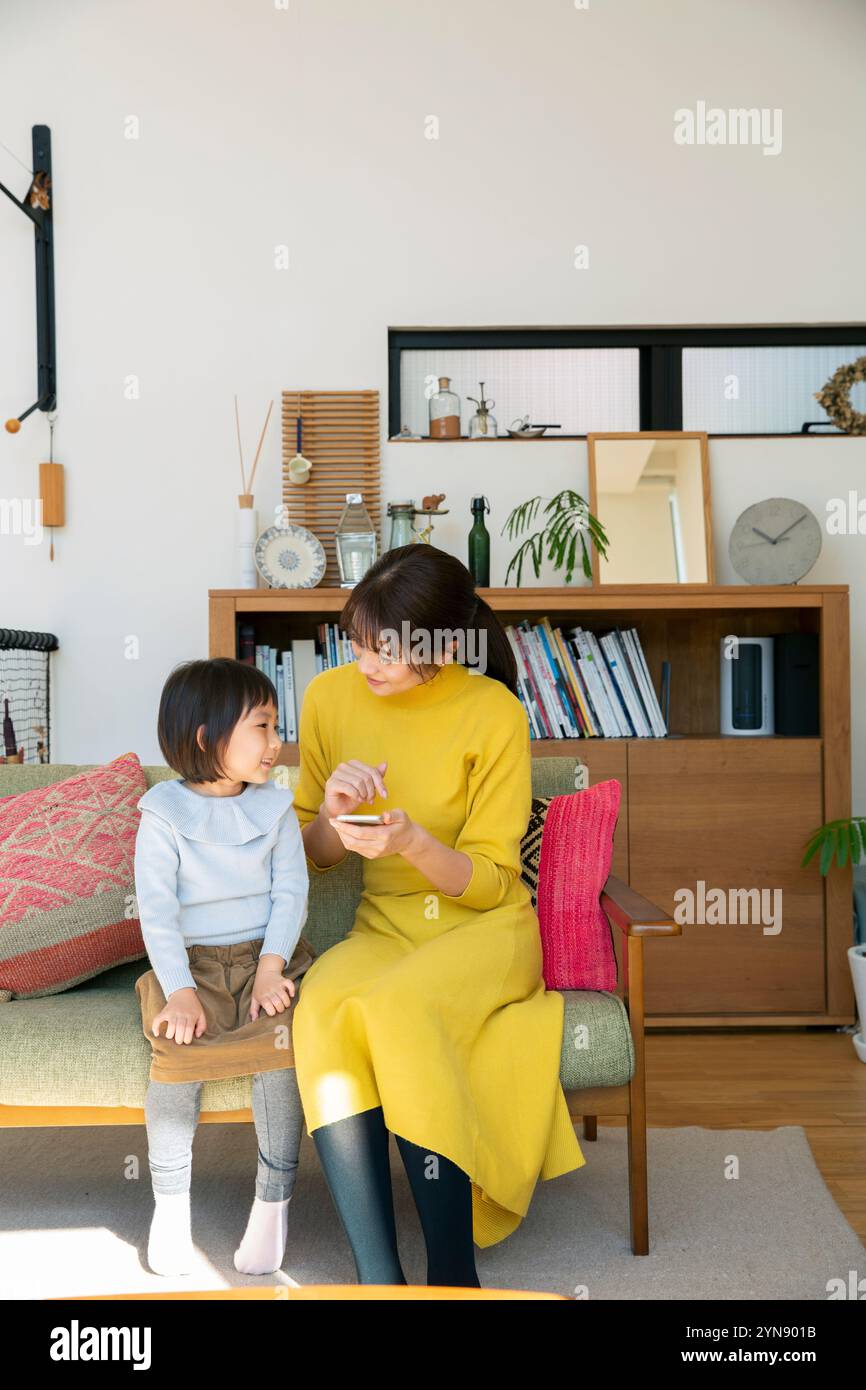 Parent and child relaxing in the living room Stock Photo - Alamy