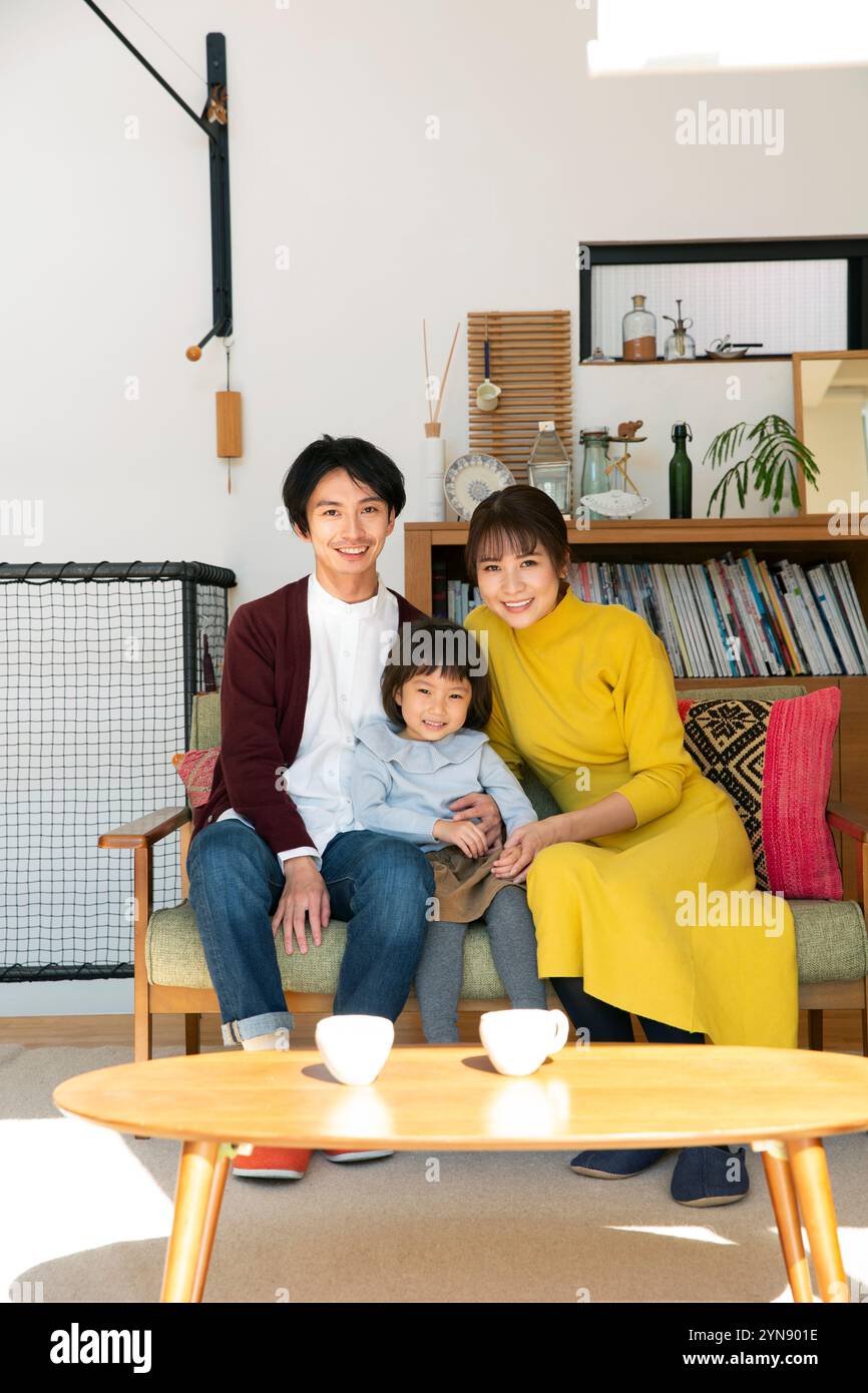 Parent and child relaxing in the living room Stock Photo - Alamy