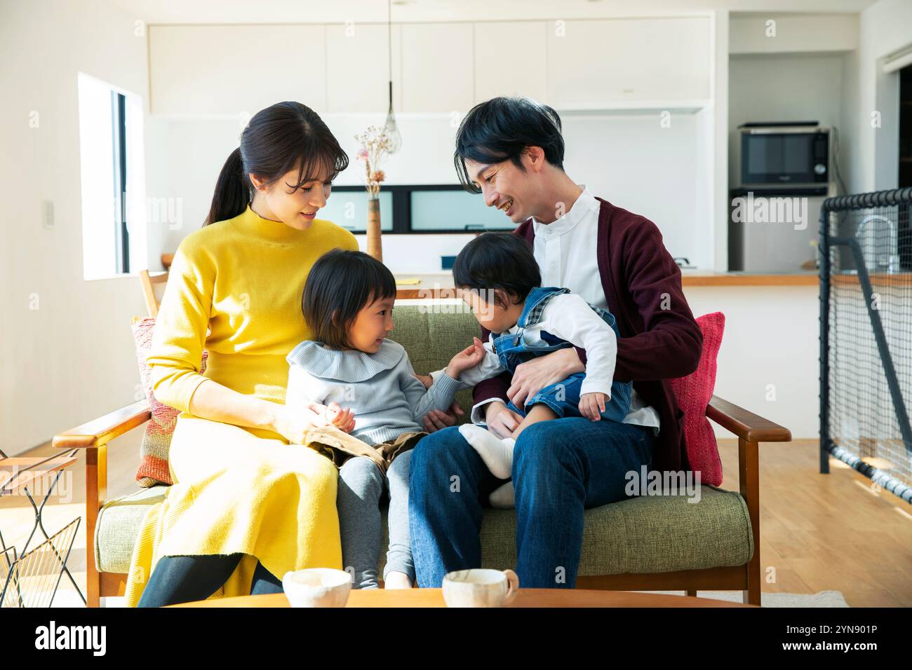 Parent and child relaxing in the living room Stock Photo - Alamy