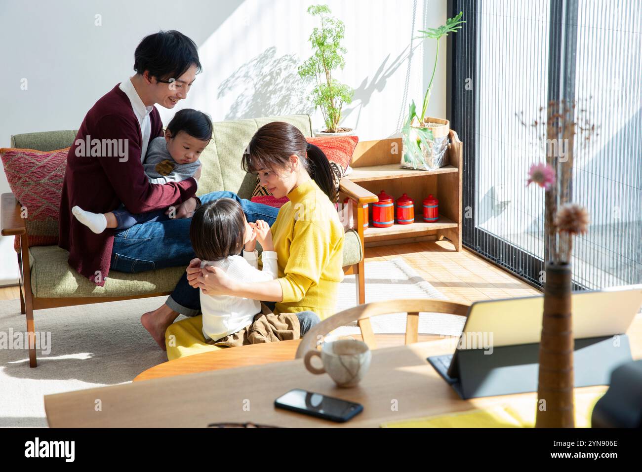 Parent and child relaxing in the living room Stock Photo - Alamy