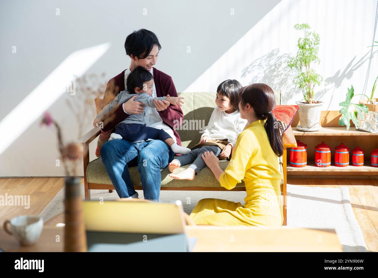 Parent and child relaxing in the living room Stock Photo - Alamy