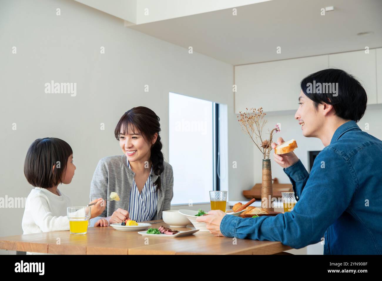 Happy family dining scene Stock Photo - Alamy