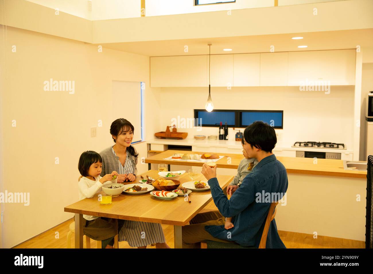 Happy family dining scene Stock Photo - Alamy