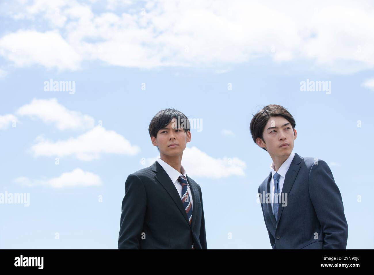 Two men in their 20s in suits standing on the rooftop Stock Photo - Alamy
