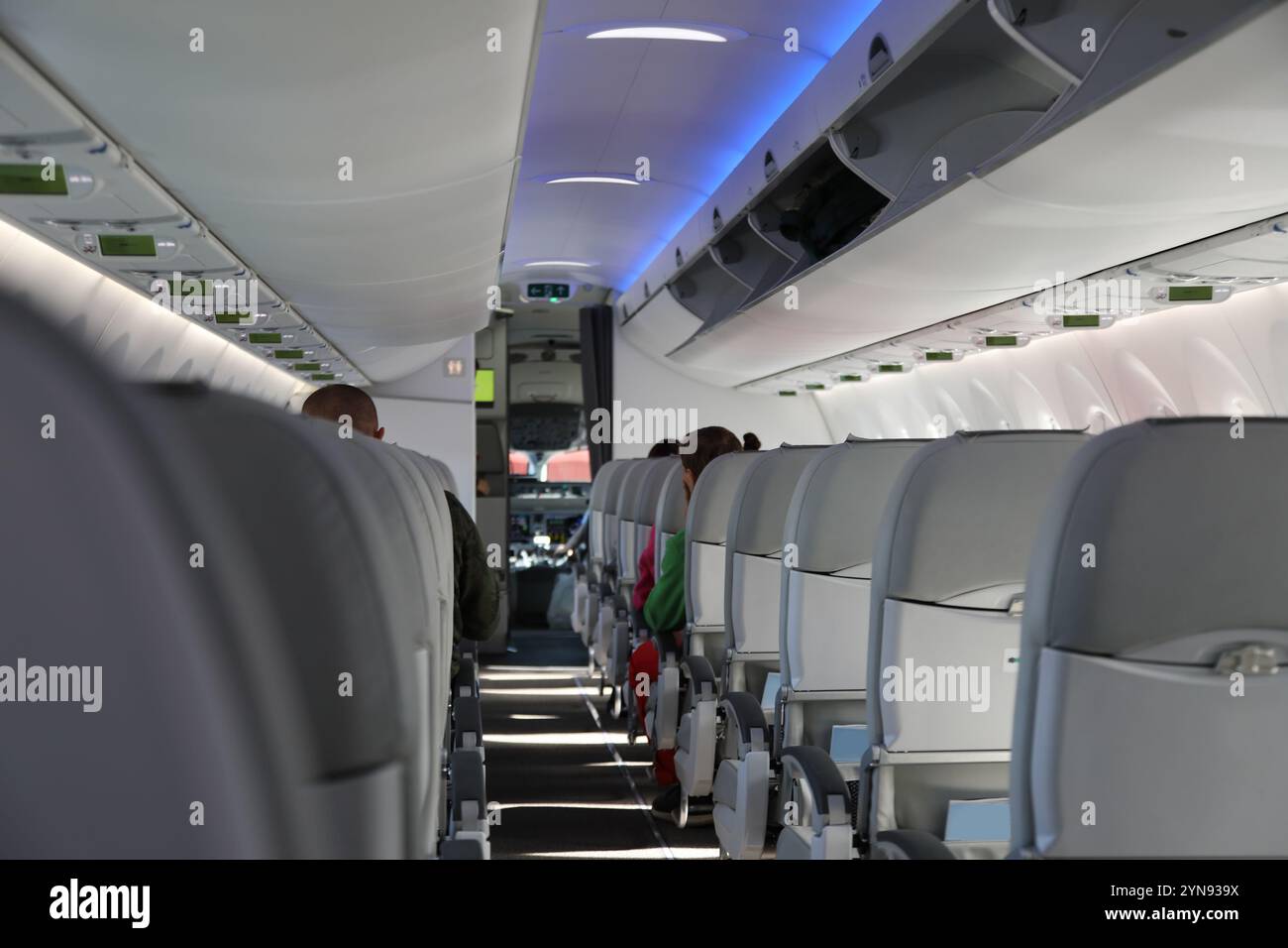 Commercial aircraft cabin with rows of seats down the aisle Stock Photo ...