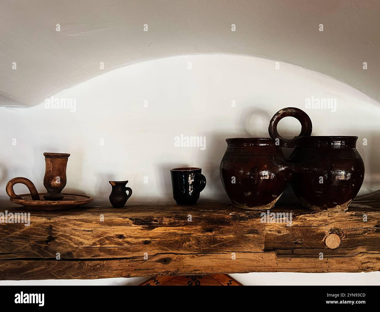 A charming display of traditional earthenware pottery on a rustic ...