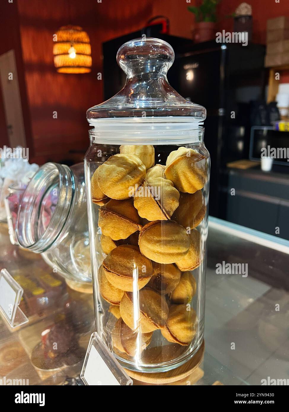 A glass jar showcasing a collection of golden brown cookies inside a ...