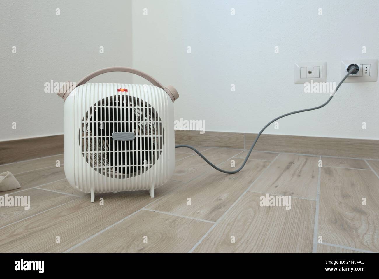 Air heater, plugged in fan on floor in room. Heating and seasons. Cold and economy Stock Photo ...