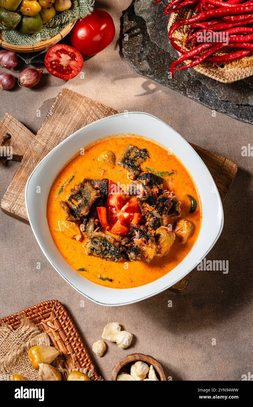 Fried eel or belut asam cikala cooked in spicy sour curry is a popular ...