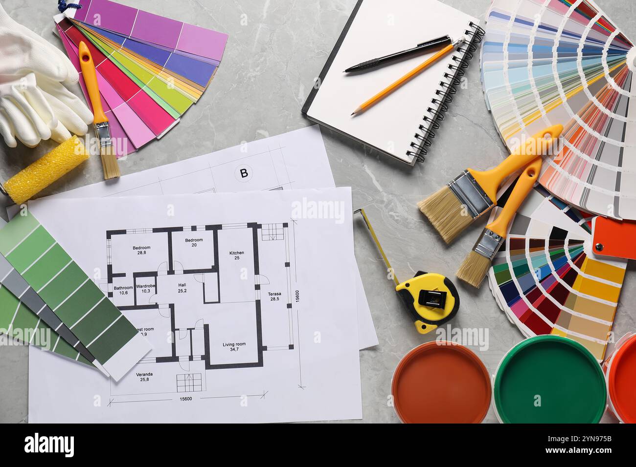 House plans and different decorator's tools on grey marble table, flat ...