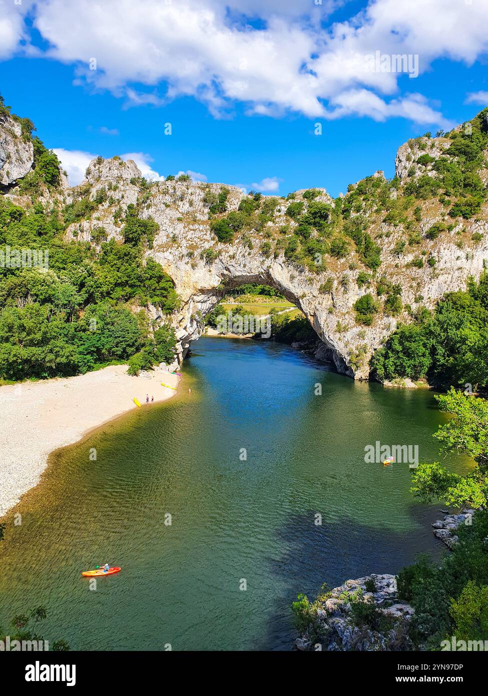 Sunlight and lush greenery framing a magnificent archway above a ...