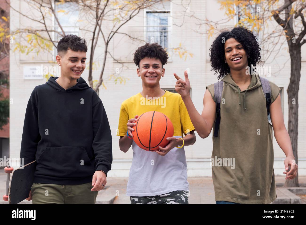 three friends talking and having fun on the street Stock Photo - Alamy