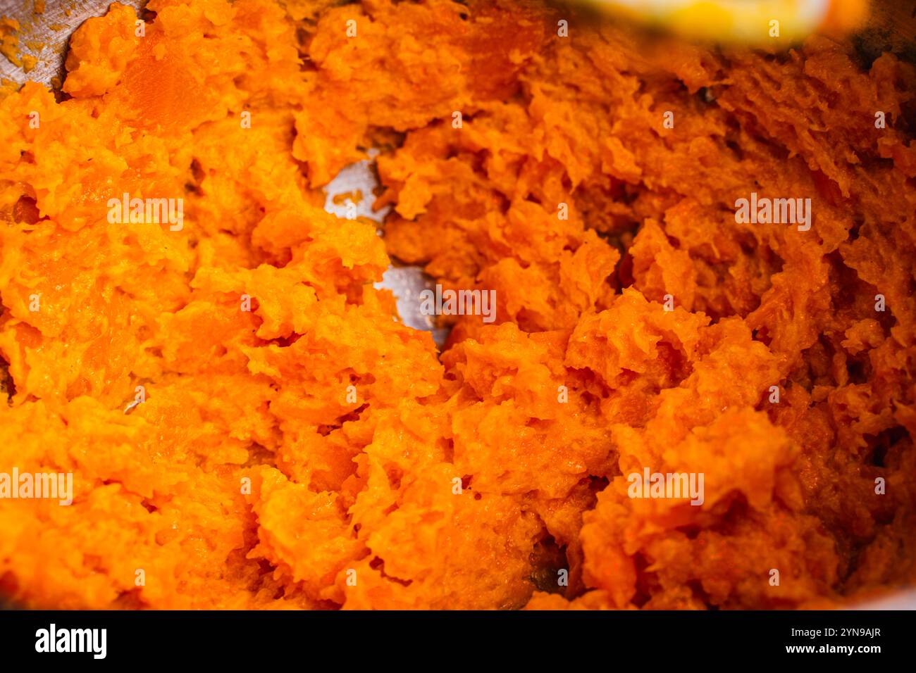 The process of making carrot puree in a planetary mixer. Close-up ...