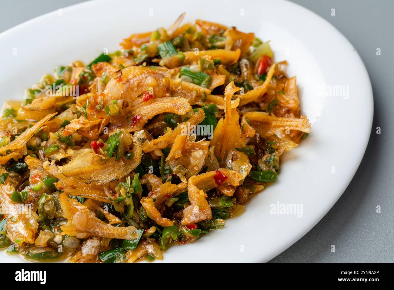 Fried anchovy cooked with green chili or ikan teri cabe ijo is a ...