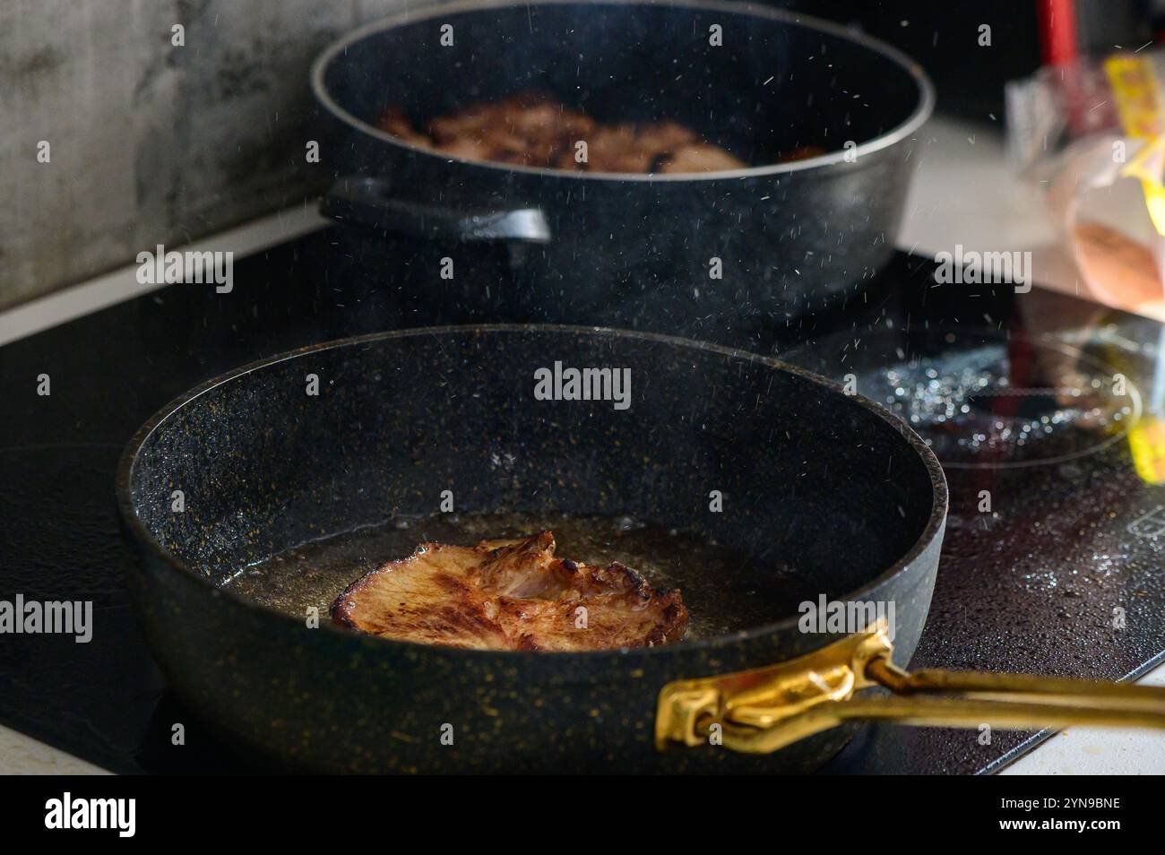 Juicy pork chops fry in hot oil, creating a tantalizing aroma and ...