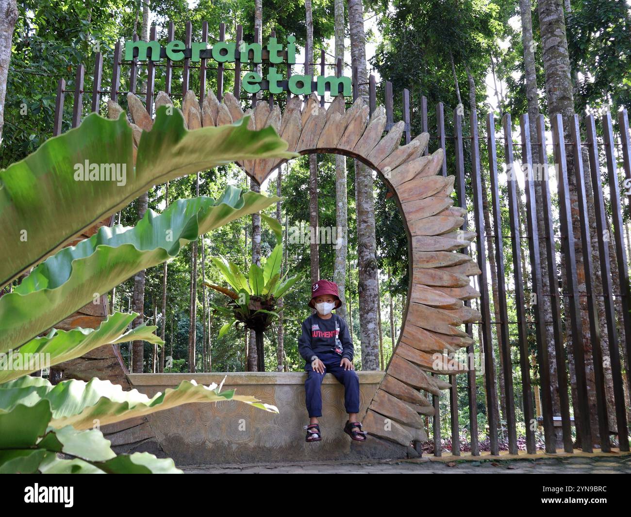Children are posing at a photogenic spot in the Meranti natural tourist ...