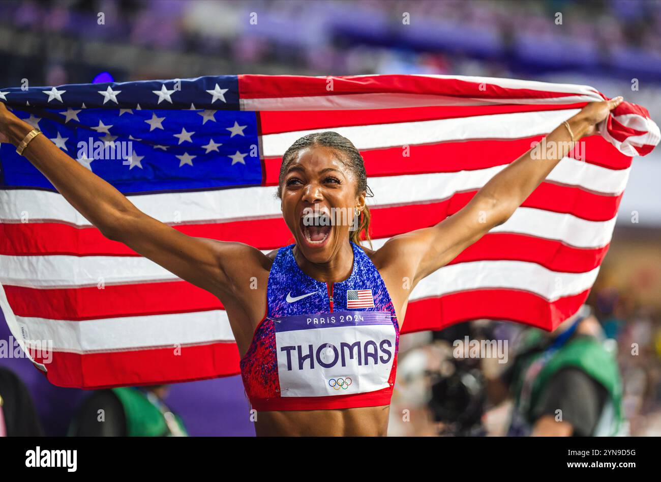Gabrielle Thomas celebrating with her country's flag in the 200 meters ...