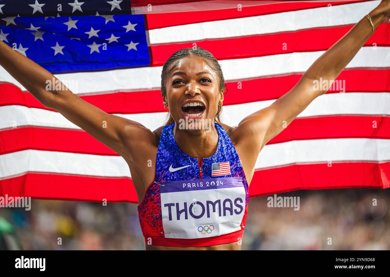 Gabrielle Thomas celebrating with her country's flag in the 200 meters ...